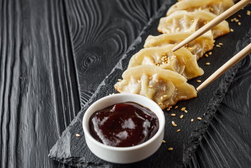 Delicious Fried Gyoza Dumplings on a Black Plate Stock Image - Image of ...
