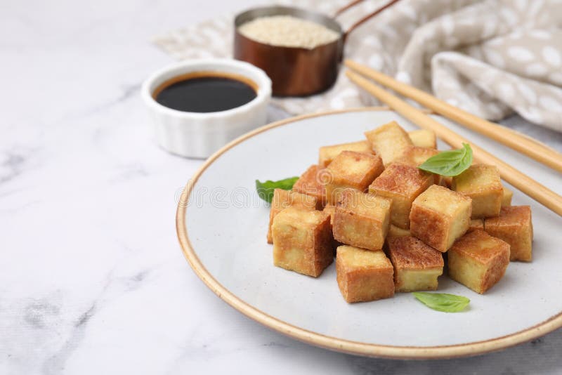Delicious Fried Tofu with Basil Served on White Marble Table, Closeup ...