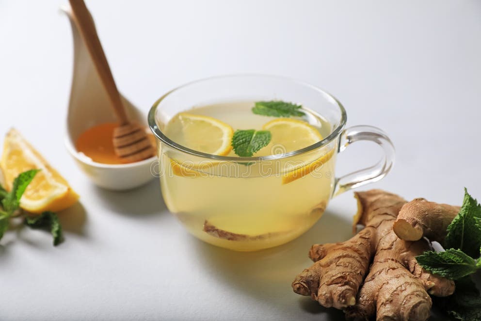 Delicious Ginger Tea and Ingredients on Light Grey Background Stock ...