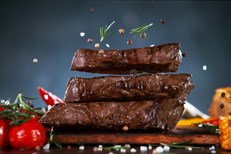 Delicious Grilled Beef Steaks Falling Down on Kitchen Board Stock Image ...