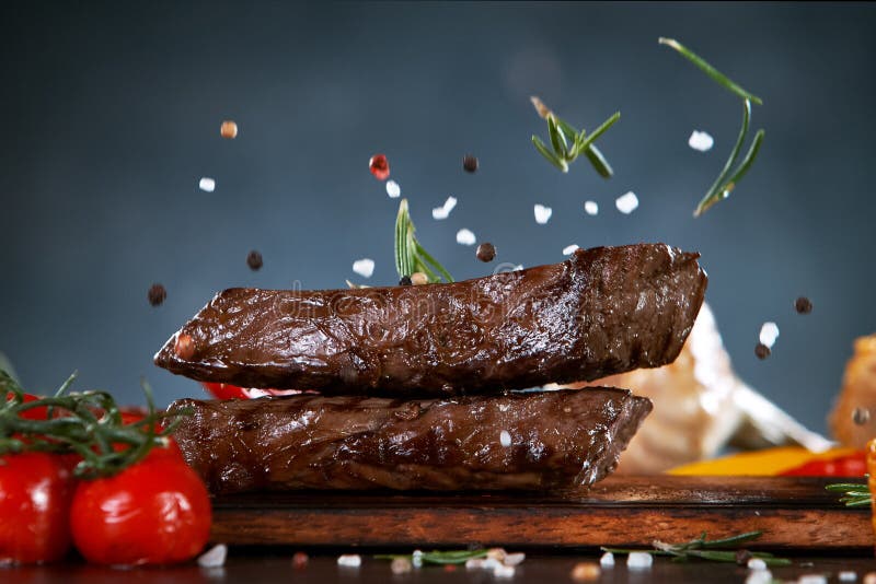 Delicious Grilled Beef Steaks Falling Down on Kitchen Board Stock Image ...