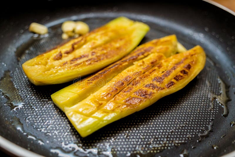 Delicious Grilled Eggplants with Garlic on the Fried Pan Stock Photo ...