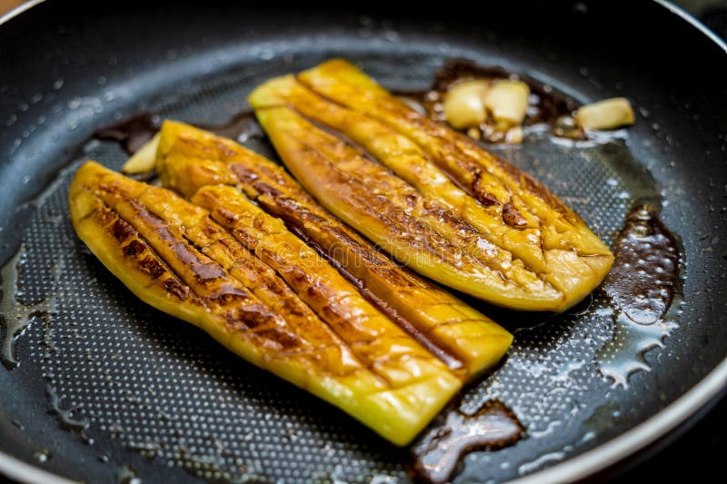 Delicious Grilled Eggplants with Garlic on the Fried Pan Stock Image ...