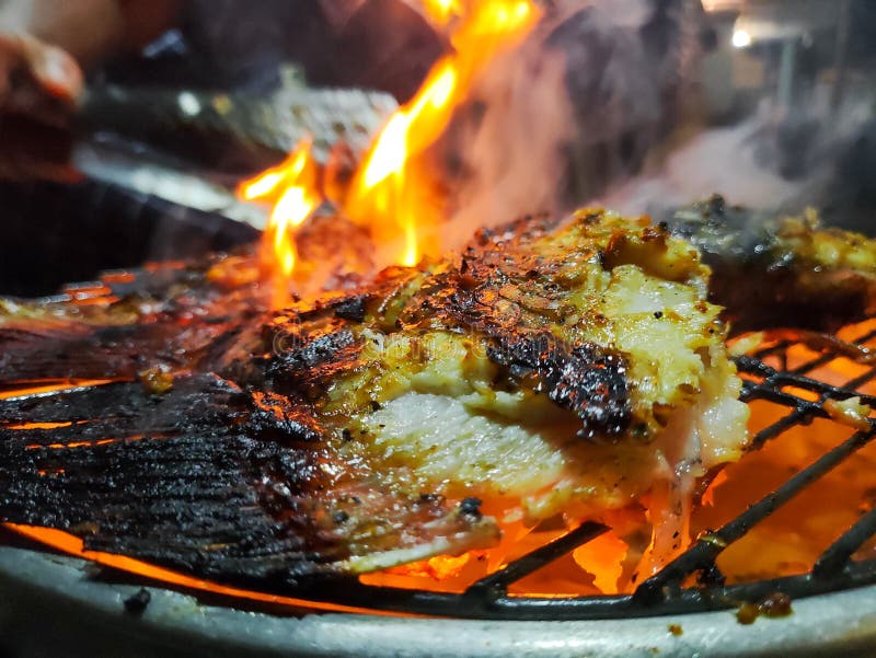 A Fish Being Grilled with a Blazing Fire on New Year Eve Stock Photo ...
