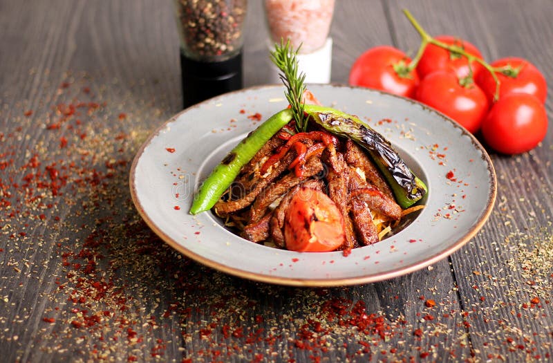 Delicious grilled meat stock photo. Image of tomatoes - 214477650