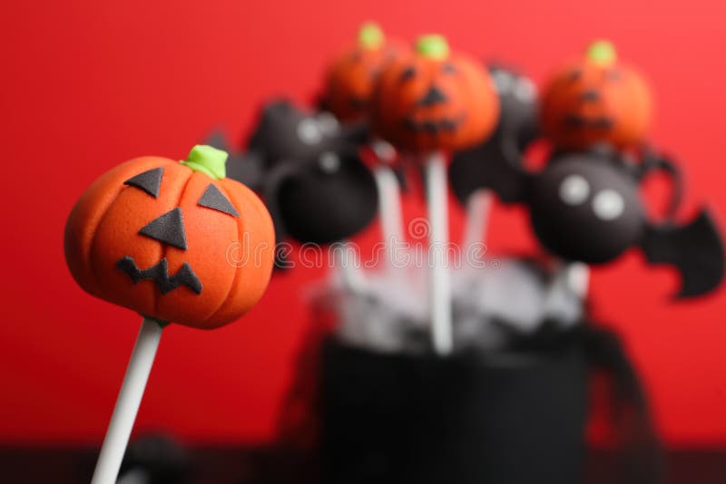 Delicious Halloween Themed Cake Pops on Red Background, Closeup. Space ...