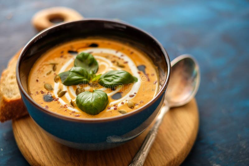 Delicious Homemade Pumpkin Soup with Basil Leaves. Stock Photo - Image ...