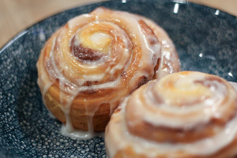 Delicious Hot Cinnamon Roll on a Blue Plate Stock Photo - Image of ...