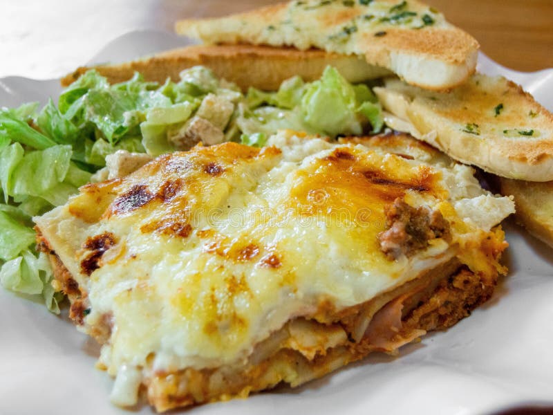 Delicious Lasagna with Vegetable Salad and Bread Stock Photo - Image of ...