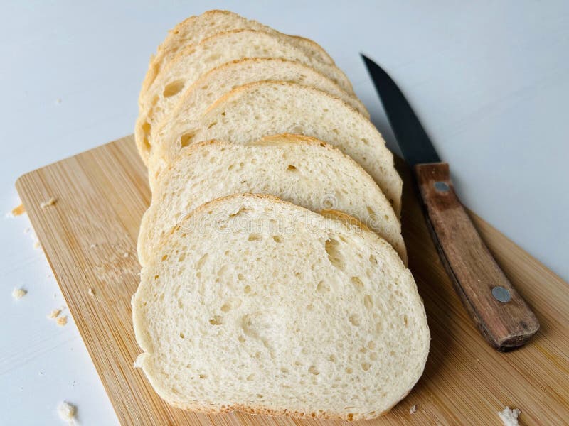 Loaf of Bun. Sliced Bread on a Cutting Board with a Knife on a White ...