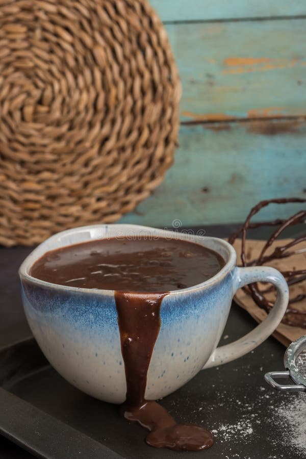 Delicious Melted Chocolate Sauce in Mug with Whisk on Table Stock Image ...