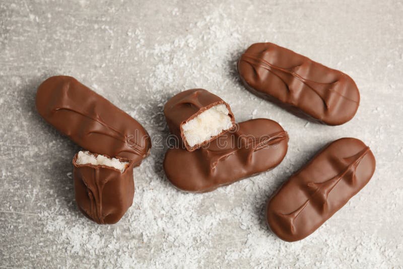 Delicious Milk Chocolate Candy Bars with Coconut Filling on Grey Table ...