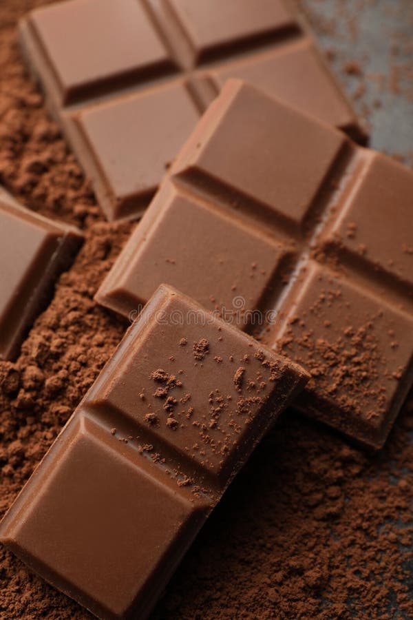 Delicious Milk Chocolate and Cocoa Powder on Grey Table, Closeup Stock ...