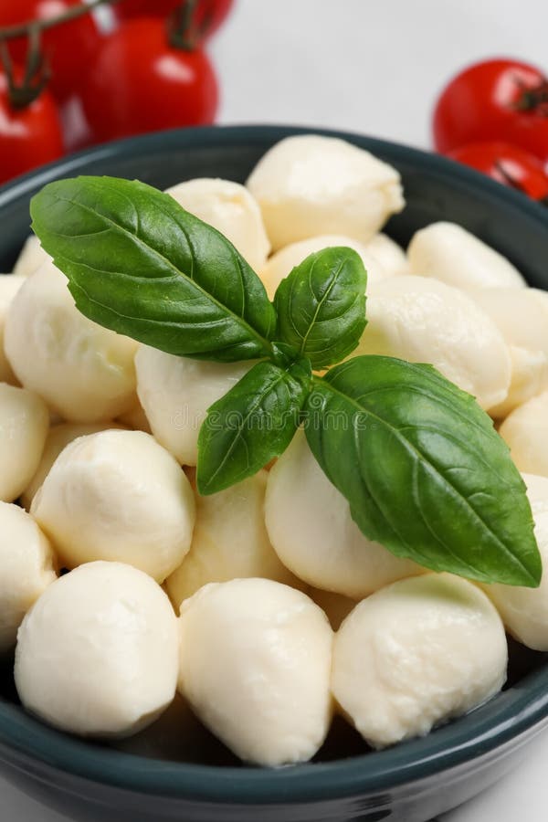 Delicious Mozzarella Balls and Basil Leaves in Bowl, Closeup Stock ...