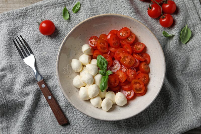 Delicious Mozzarella Balls, Tomatoes and Fork on Table, Flat Lay Stock ...