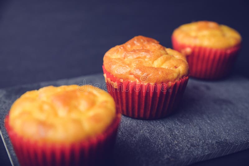 Yummy muffins in a row stock photo. Image of plating - 109779416