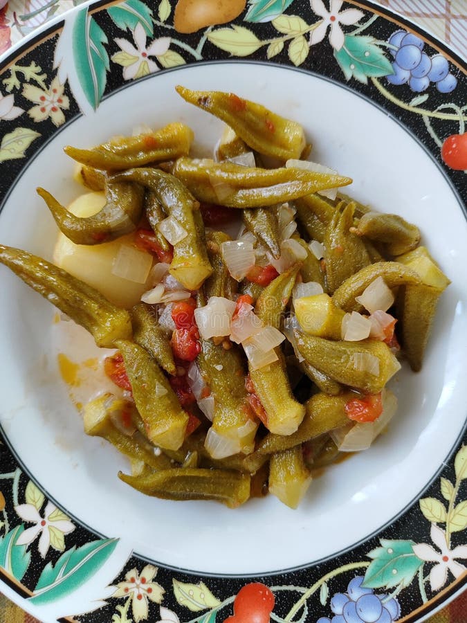 Okra Dish on the Plate with Tomato Sauce on Gray Background, Top View ...