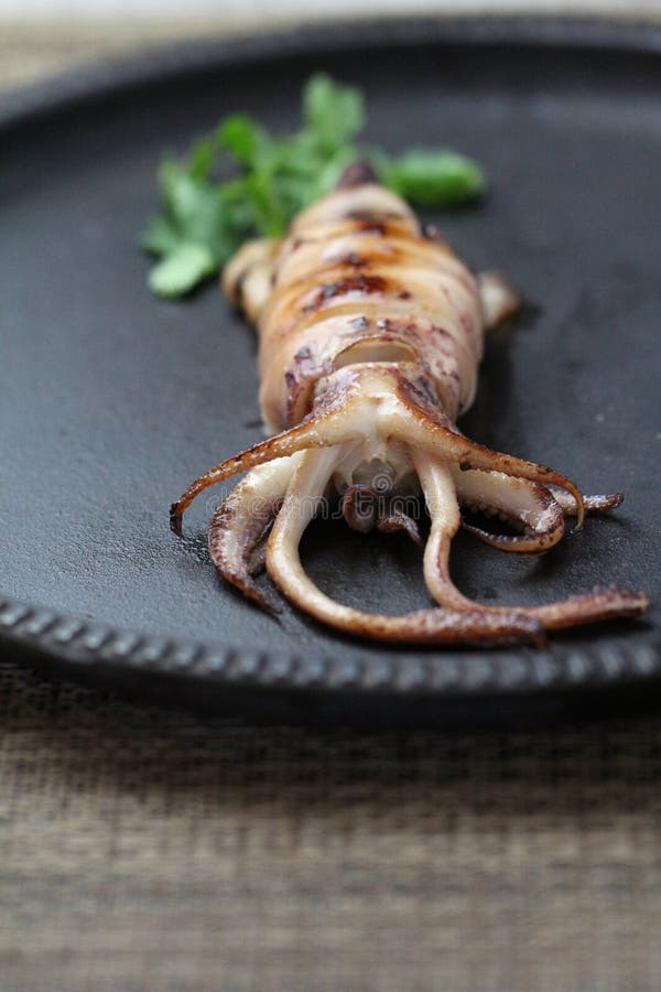Delicious Pan-fried Arrow Squid on Cast Iron Stock Image - Image of ...