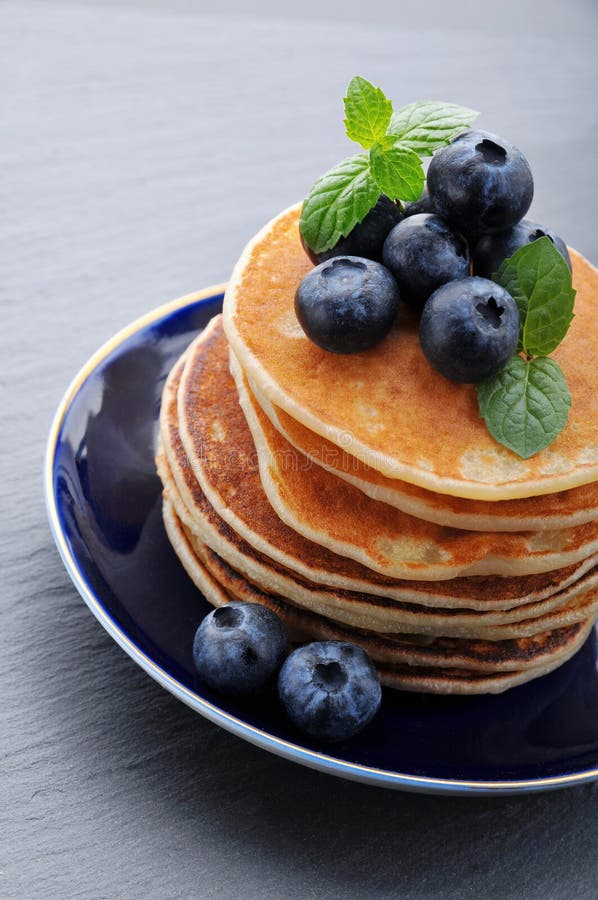 Delicious Pancakes with Berries and Honey on a White Wooden Board Stock ...
