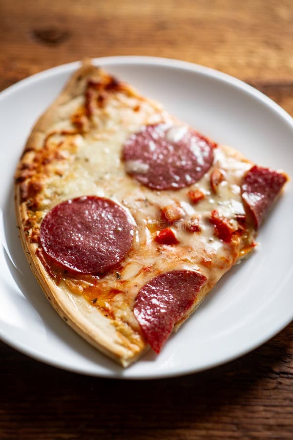 Delicious Pepperoni Pizza Slice on White Plate with Melty Cheese and ...