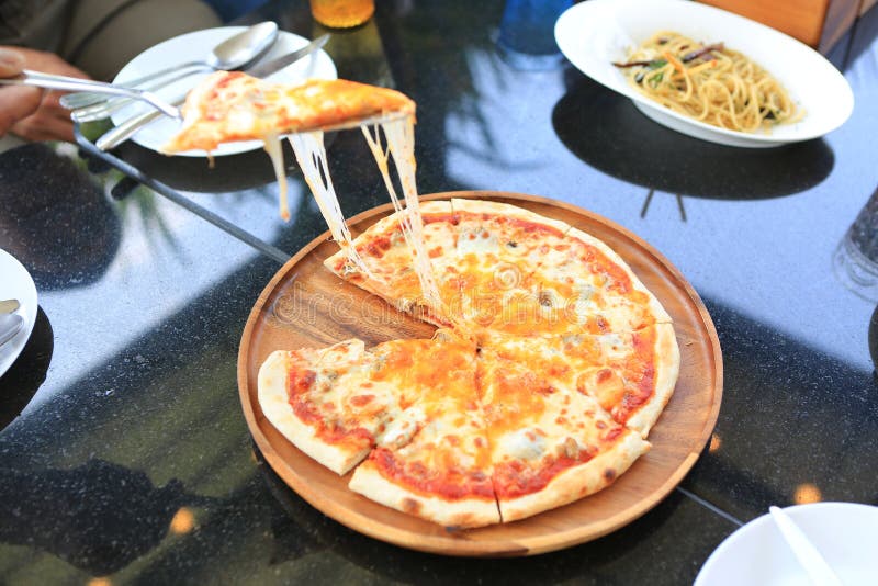 Delicious Pizza with Cheese Stretch while Eating Stock Photo - Image of ...