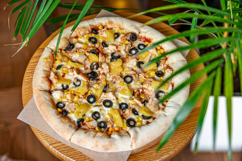 Delicious Pizza with Chicken Meat, Pineapple, Corn and Olives Stock ...