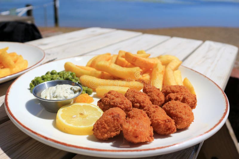Plate of Scampi and Chips on a Wooden Table by the Sea Stock Image ...