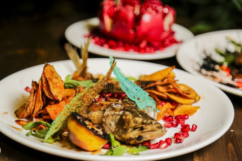 Delicious Plated Fish Dish with Colorful Accompaniments at a Dining ...