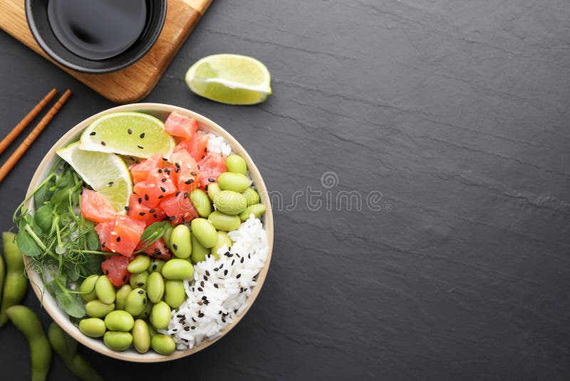 Delicious Poke Bowl with Lime, Fish and Edamame Beans on Black Table ...