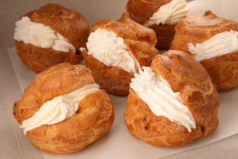 Delicious Profiteroles with Cream Filling on Table, Closeup Stock Photo ...