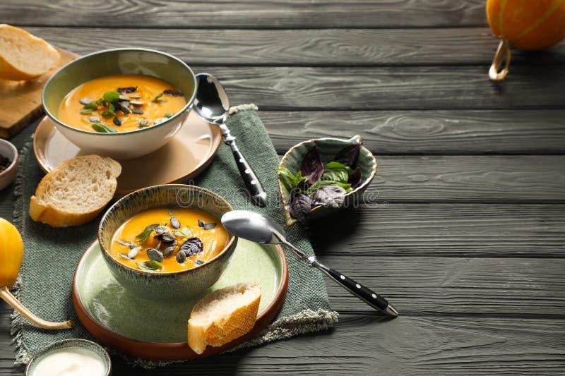 Delicious Pumpkin Soup Served on Grey Wooden Table, Space for Text ...