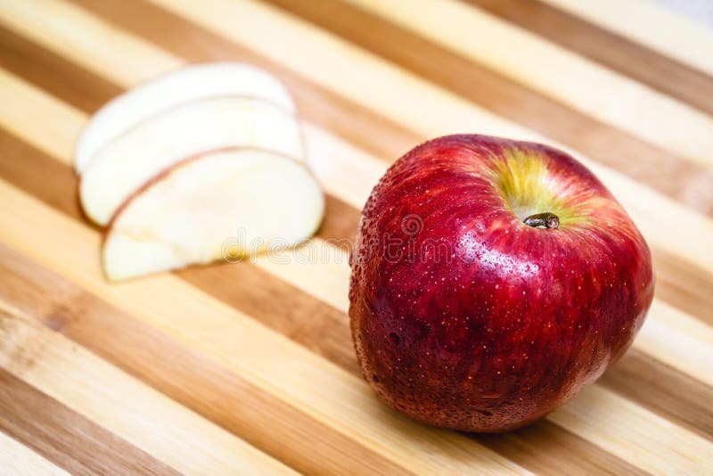 Delicious Red Apple Next To Slices of Another Apple. Stock Photo ...