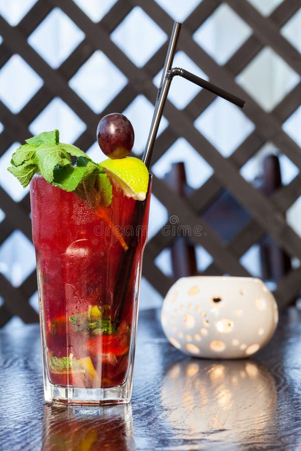 A Delicious Red Cocktail with Mint on a Table Stock Photo - Image of ...