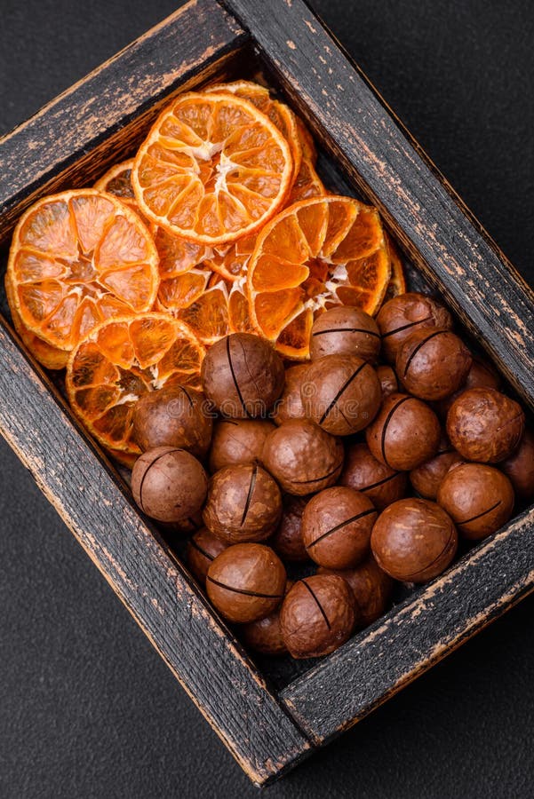 Delicious Roasted Macadamia Nuts in Shell on a Dark Textured Background ...