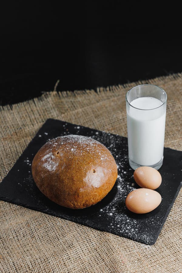 Delicious Round Rye Bread with Milk and Eggs on a Dark Background Stock ...