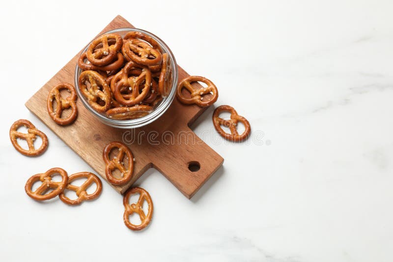Delicious Salty Pretzel Crackers on White Table, Top View. Space for ...