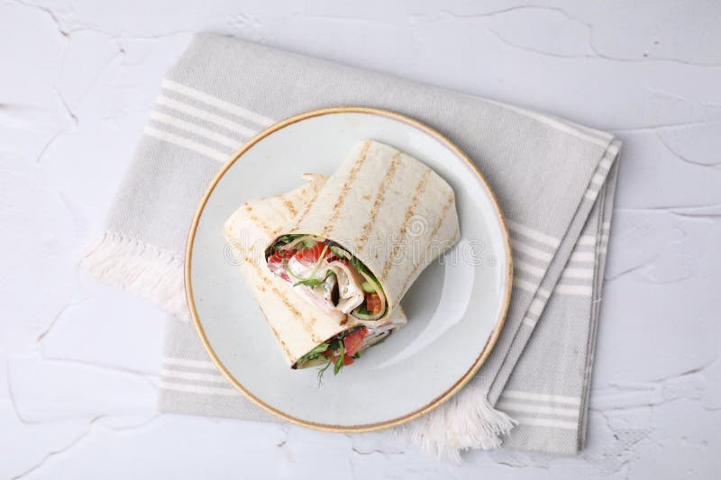 Delicious Sandwich Wraps with Fresh Vegetables on White Textured Table ...