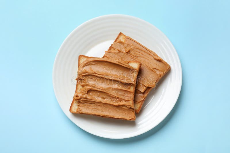 Delicious Sandwiches with Peanut Butter on Light Blue Table, Top View ...