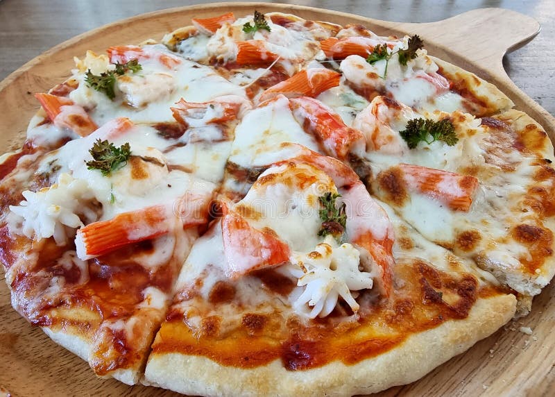 Seafood Cocktail Pizza Separated on the Plate with Knife and Fork Stock ...