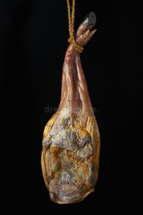 Delicious Serrano Ham Hanging from a Rope. Isolated on Black ...
