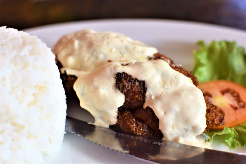 A Delicious Serving of Creamed Breaded Chicken and Steamed Rice Stock ...