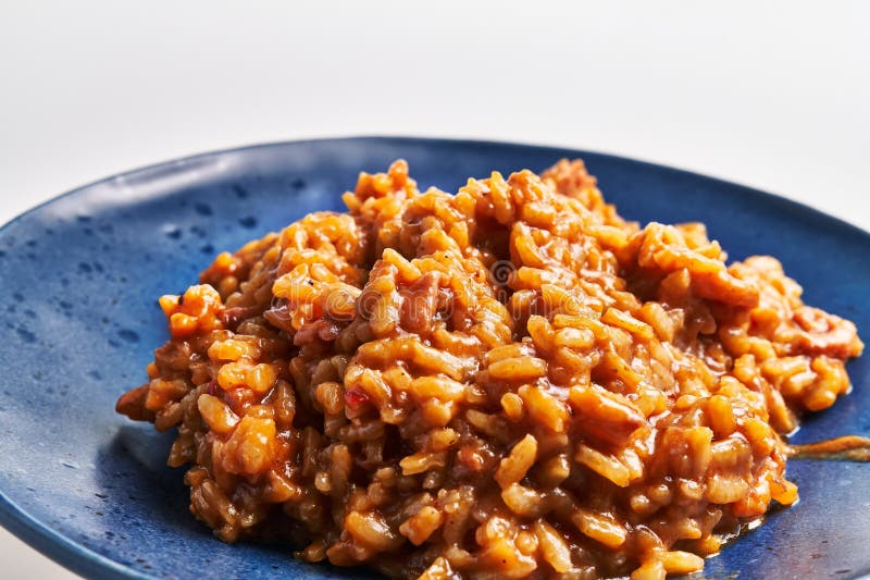 A Delicious Serving of Risotto Presented on a Blue Plate Against a ...