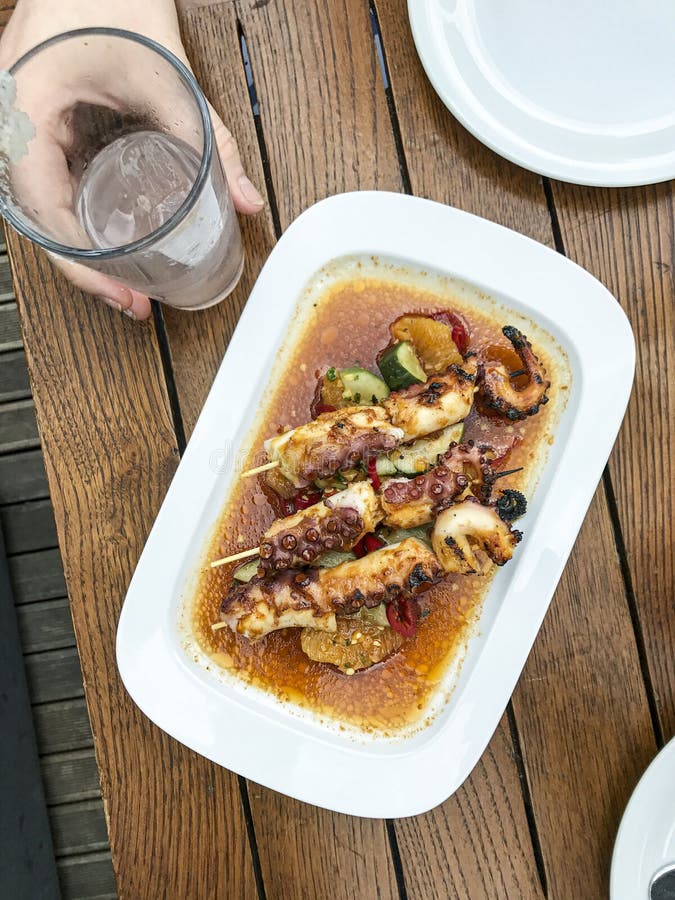 Delicious skewered octopus stock image. Image of isolated - 156341567