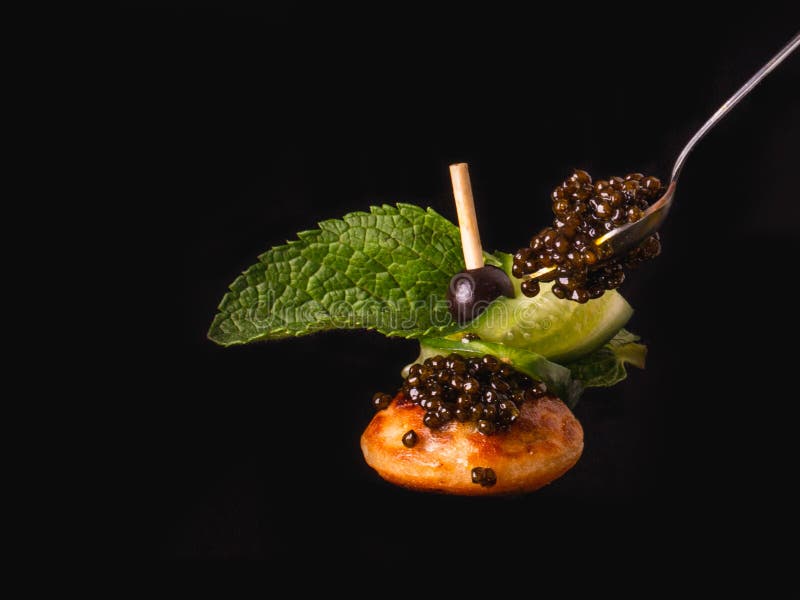 Delicious Snack with Black Caviar, Mint and Cucumber Stock Image ...