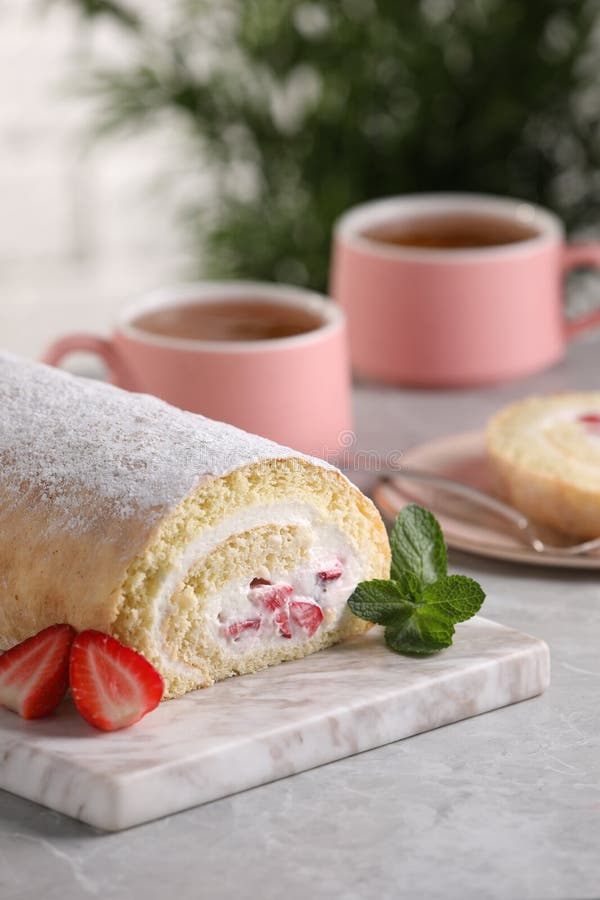Delicious Sponge Cake Roll with Strawberries and Cream on Light Grey ...
