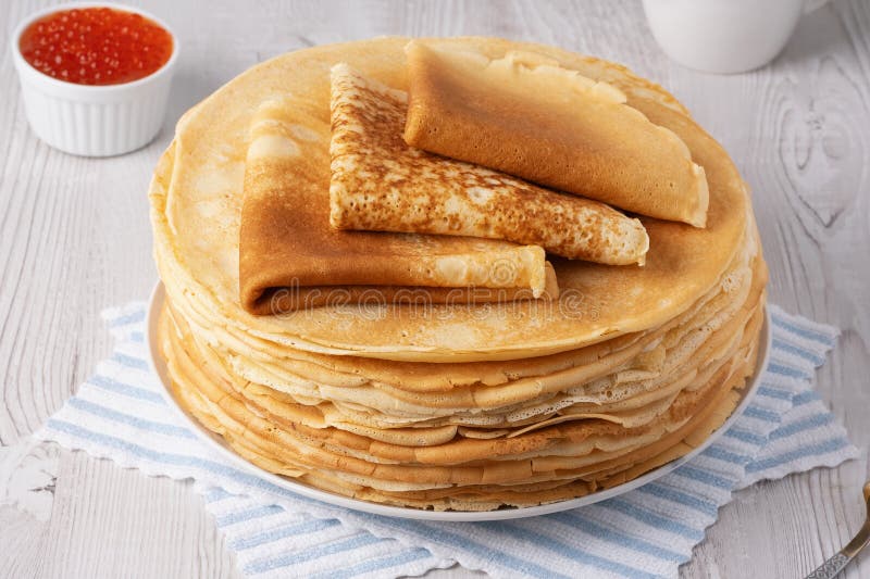 Delicious Stack of Golden Pancakes Served with Caviar on a Rustic Table ...