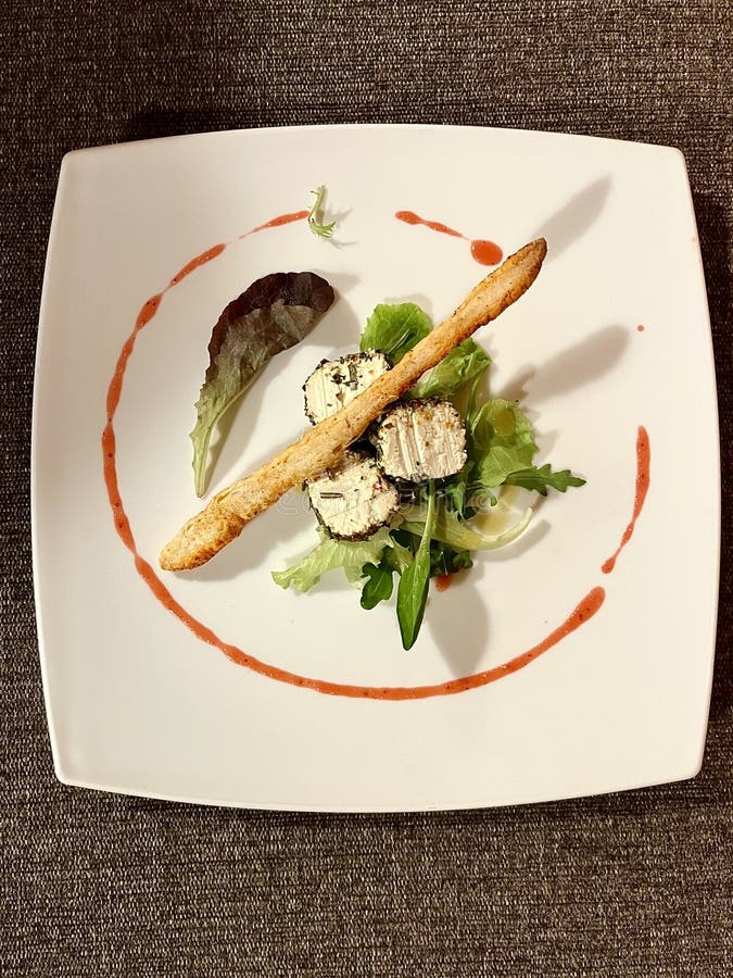 A Nice Starter with Goat Cheese and Different Salad Leaves on a Plate ...