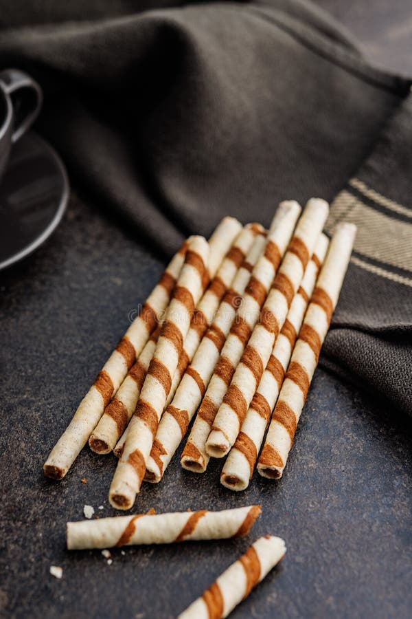 Delicious Striped Wafer Rolls on Dark Table Stock Photo - Image of ...
