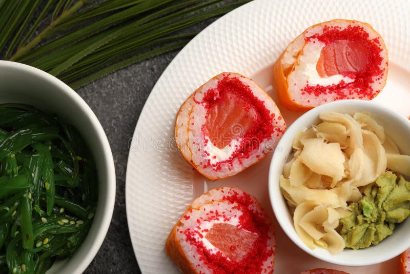 Delicious Sushi Rolls with Wasabi, Ginger and Chuka on Grey Textured ...