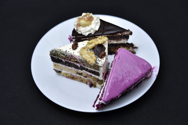 Delicious Sweet Cakes on a Plate. Sliced Cake with Nuts and Sweets ...